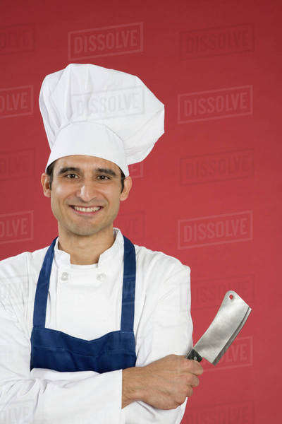 Hispanic chef holding cleaver - Royalty-free Stock Photo | Dissolve