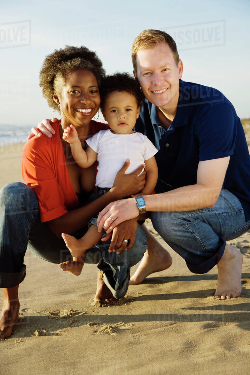 Multi-ethnic family enjoying beach - Royalty-free Stock Photo | Dissolve