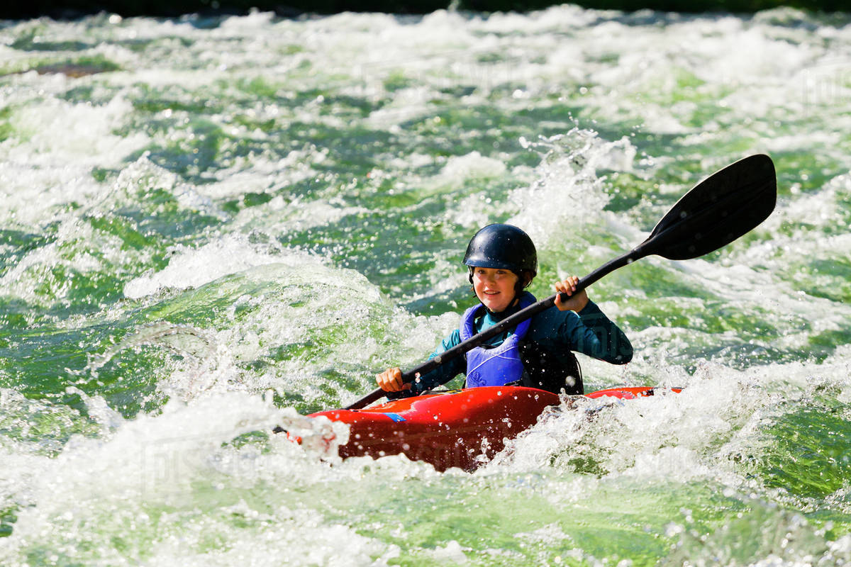 Caucasian girl kayaking in river - Stock Photo - Dissolve