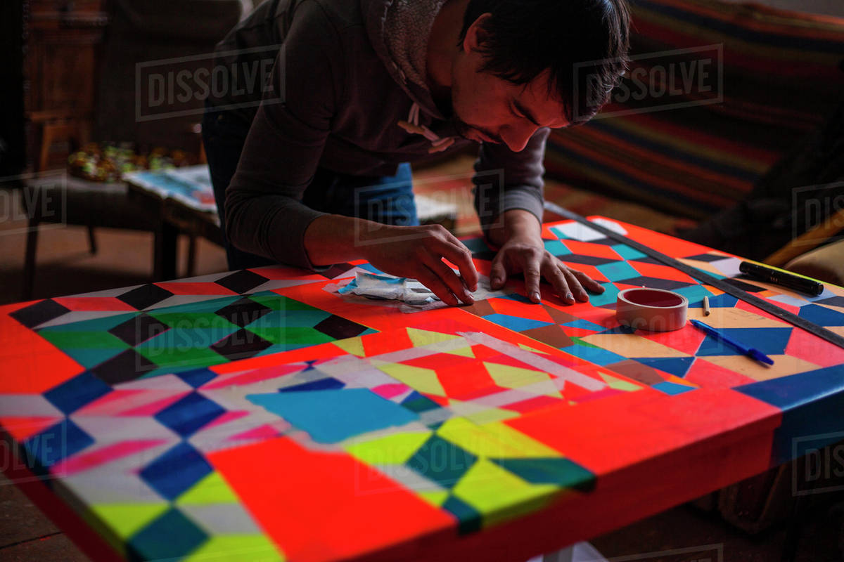 Mari man designing colorful table - Royalty-free Stock Photo | Dissolve