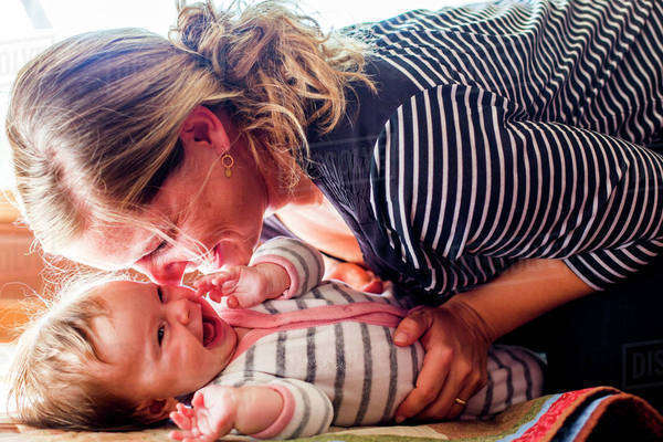 Smiling Caucasian mother cradling baby girl - Royalty-free Stock Photo ...