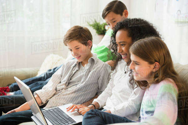 Children using laptop on sofa - Royalty-free Stock Photo | Dissolve