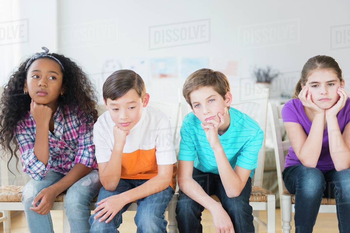 Bored children resting chins in hands - Royalty-free Stock Photo | Dissolve