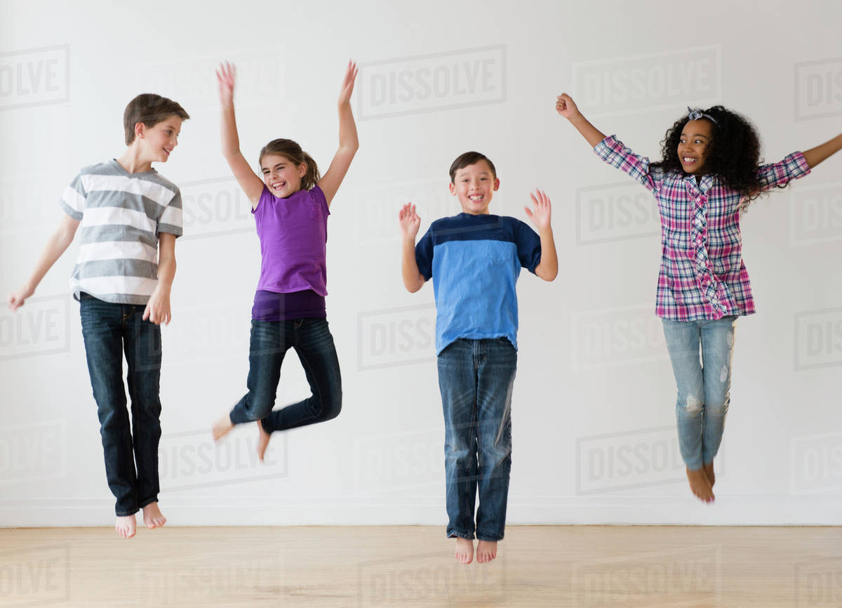 Smiling children jumping for joy in studio - Royalty-free Stock Photo ...