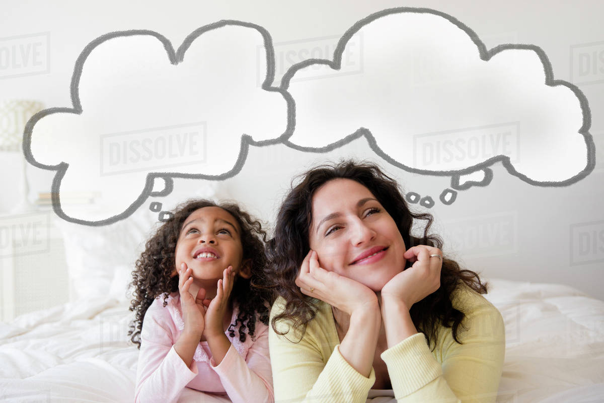 Mother and daughter thinking on bed - Royalty-free Stock Photo | Dissolve