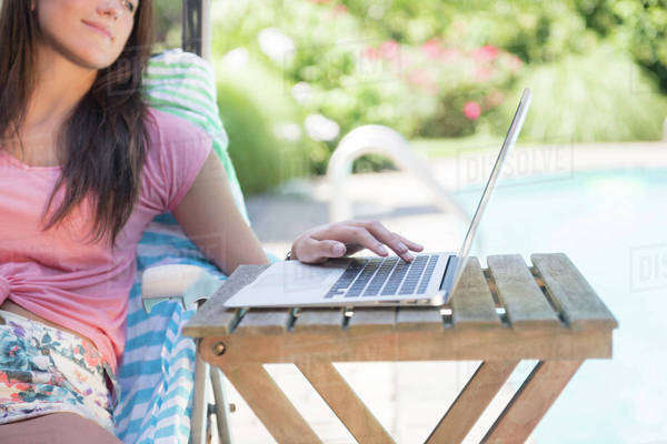 Caucasian woman using laptop outdoors - Royalty-free Stock Photo | Dissolve