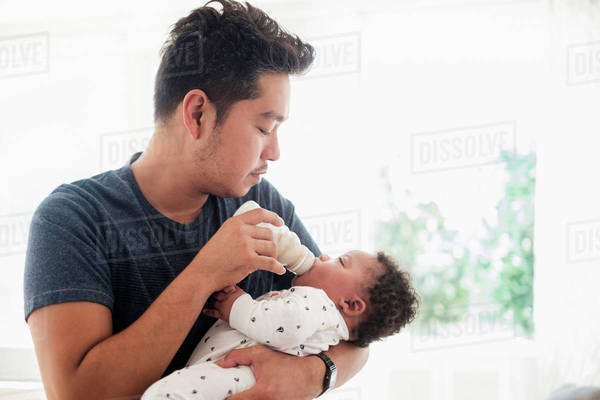 Father bottle feeding baby son - Royalty-free Stock Photo | Dissolve