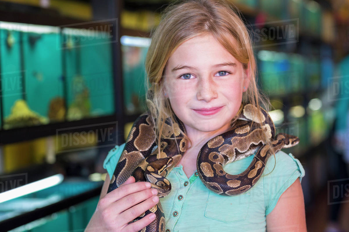 Caucasian girl holding snake in pet store - Royalty-free Stock Photo ...