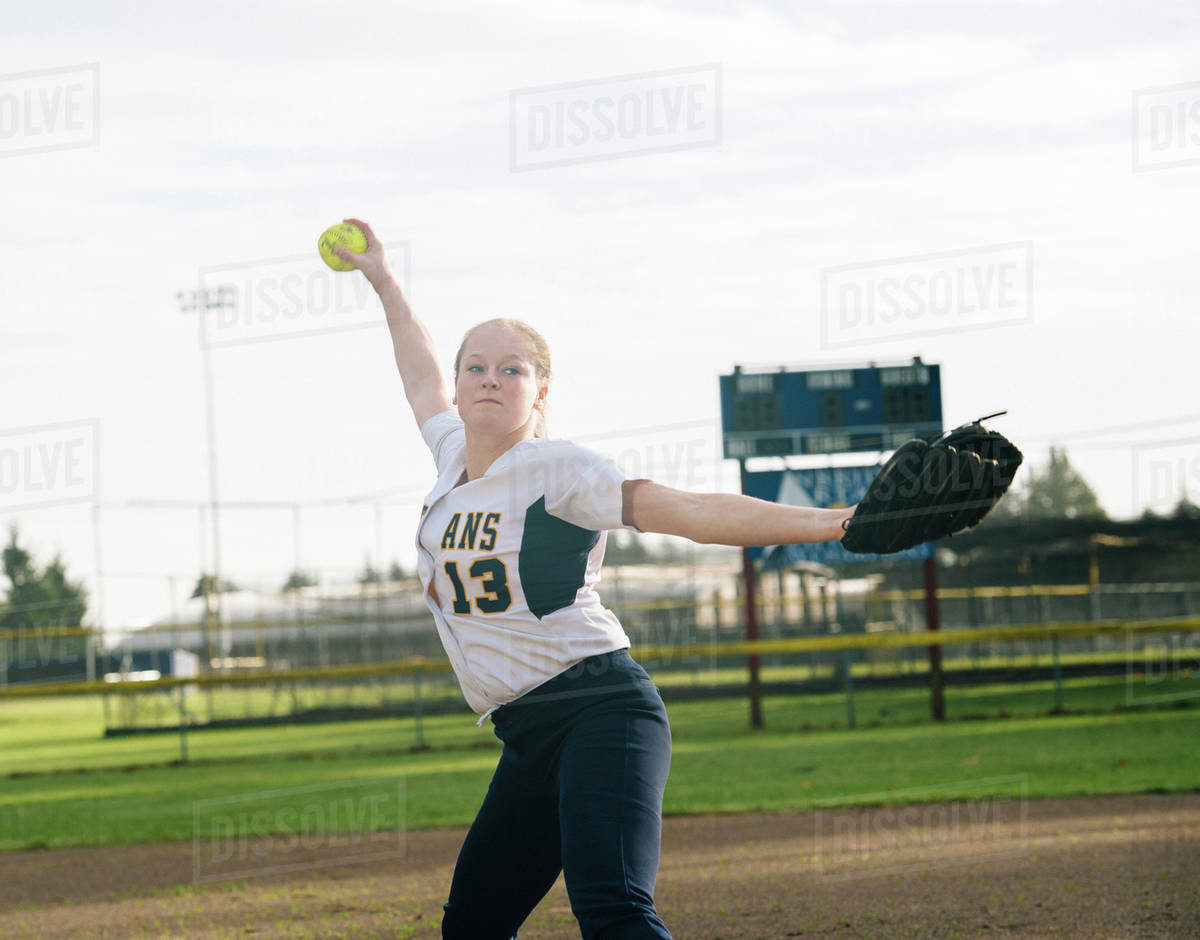 Caucasian softball player pitching ball in field - Royalty-free Stock ...