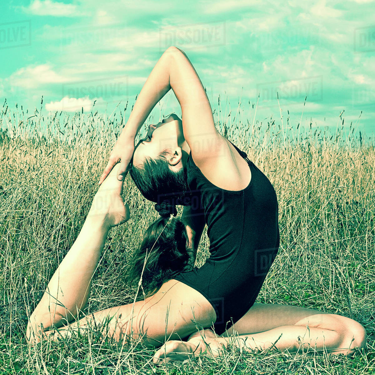 Caucasian woman doing backbend in tall grass - Royalty-free Stock Photo ...