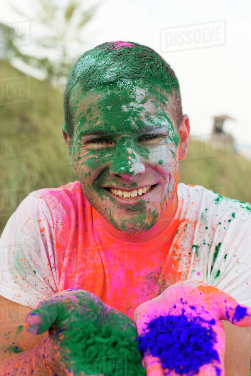 Caucasian man splattered with paint powder showing hands - Royalty-free ...