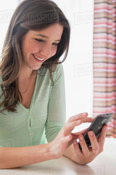 Smiling Caucasian woman texting on cell phone - Royalty-free Stock ...