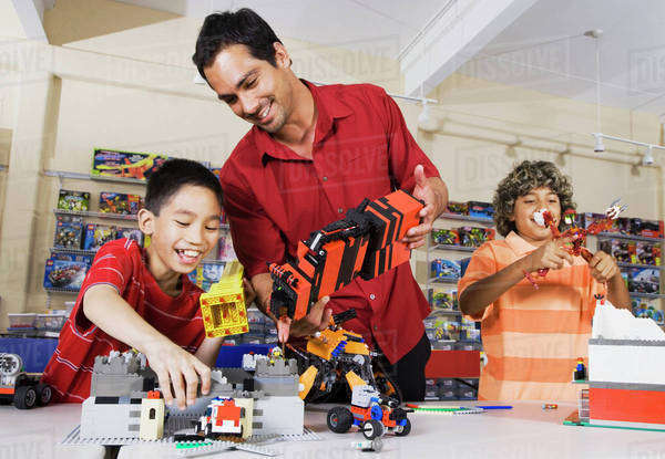 Multi-ethnic children playing at toy store - Stock Photo - Dissolve