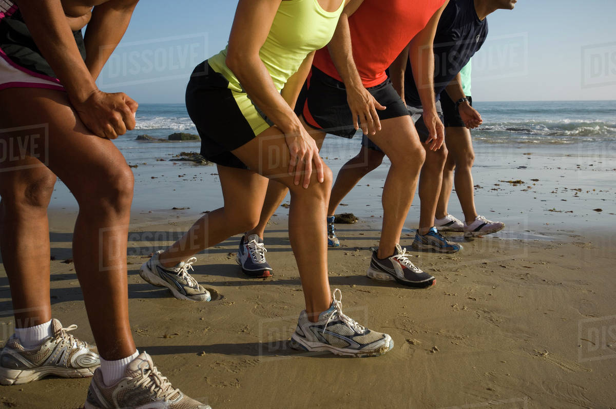 Multi-ethnic runners racing at beach - Stock Photo - Dissolve