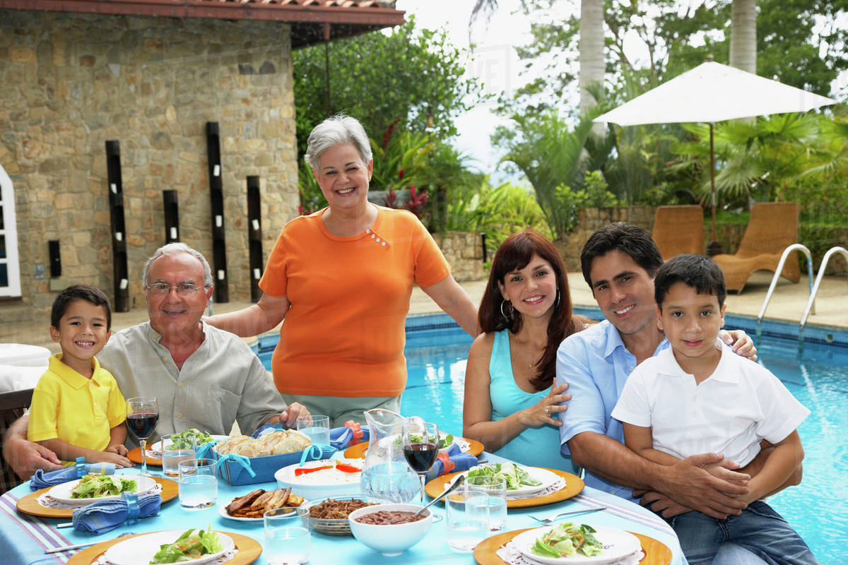 Multi-generational Hispanic family eating outdoors - Royalty-free Stock ...