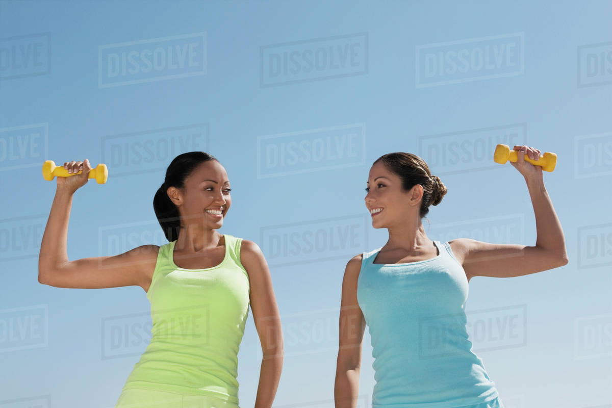 Hispanic women exercising with dumbbells - Royalty-free Stock Photo ...