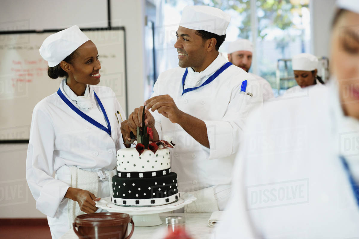 African pastry chefs decorating cakes - Royalty-free Stock Photo | Dissolve
