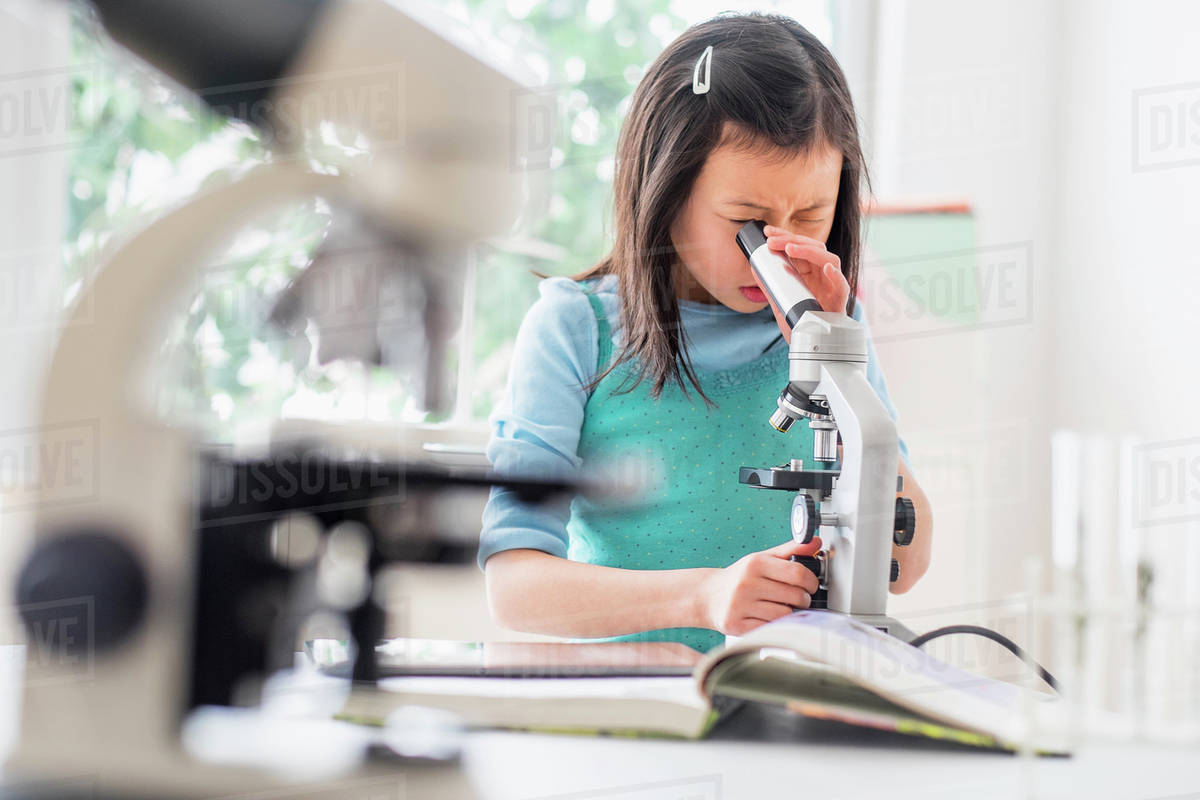 Chinese student using microscope in science lab - Royalty-free Stock ...
