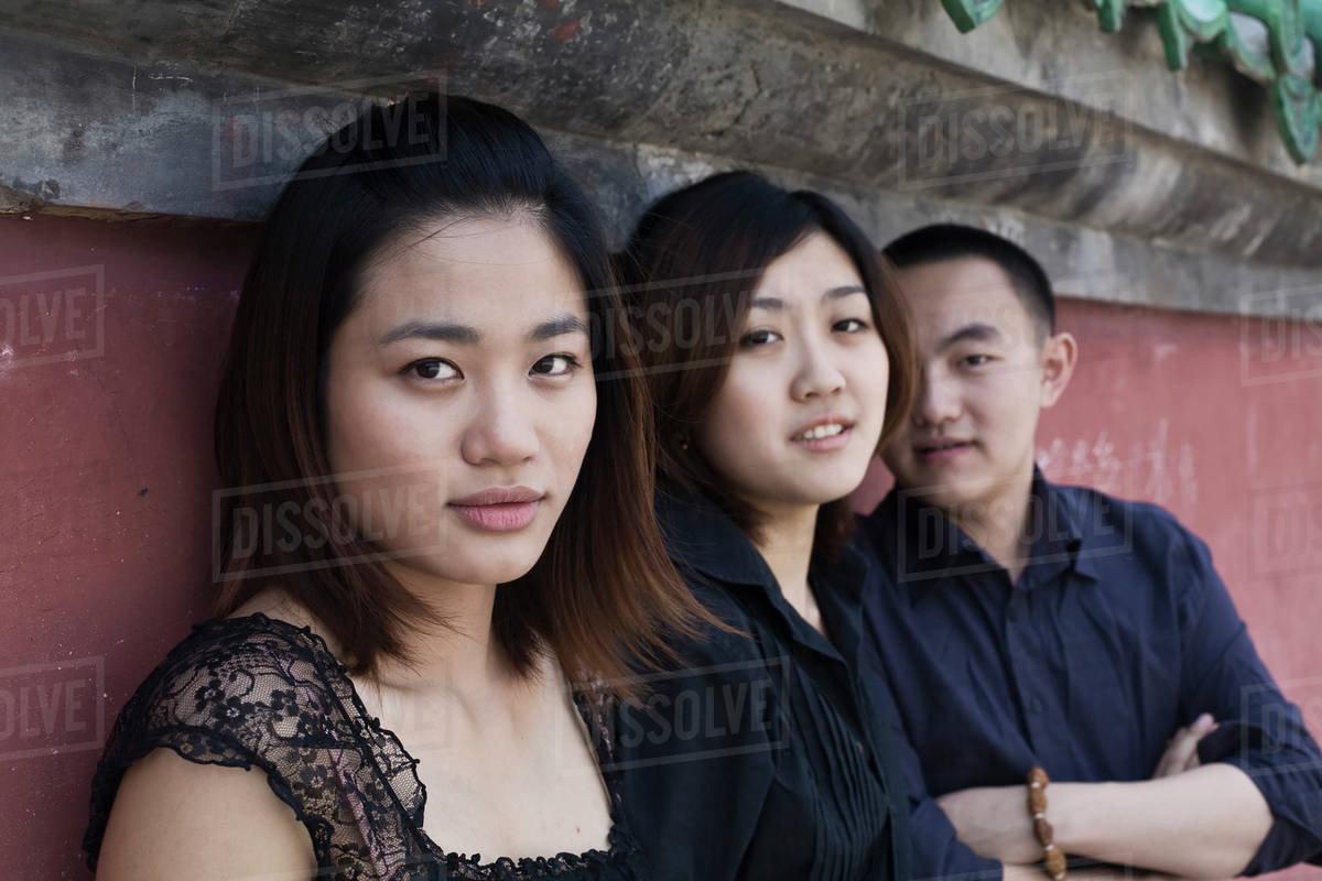 Chinese friends sitting outdoors - Royalty-free Stock Photo | Dissolve