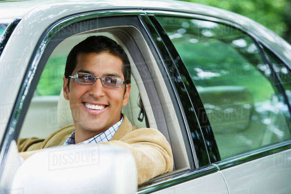 Hispanic man driving car - Royalty-free Stock Photo | Dissolve