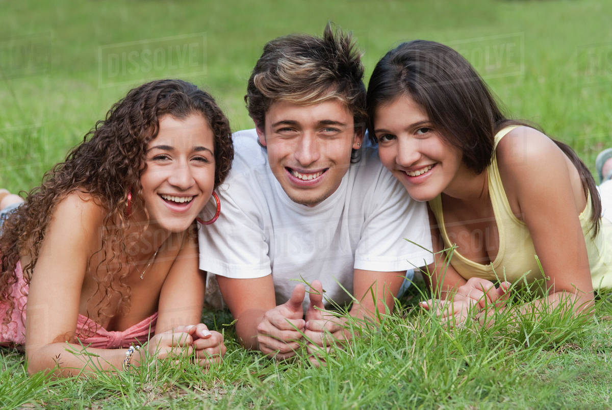 Hispanic friends laying in grass together - Royalty-free Stock Photo ...