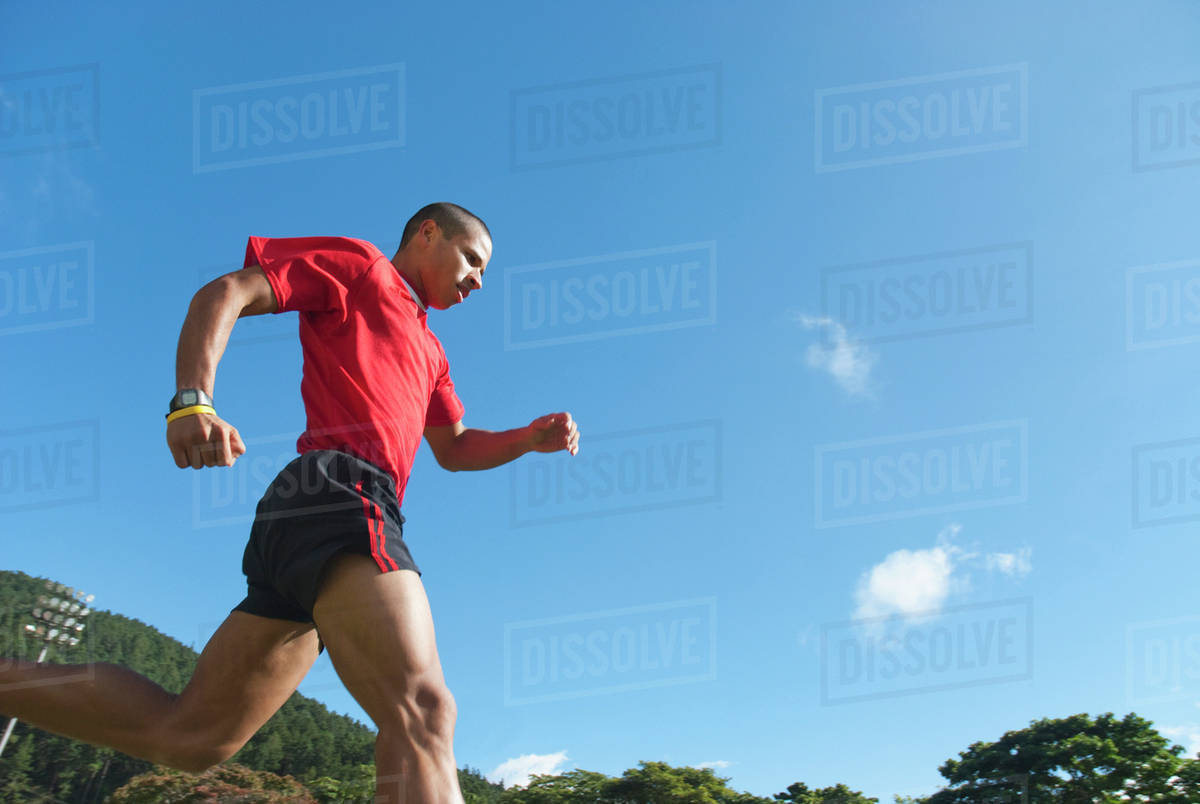 Hispanic man running - Stock Photo - Dissolve