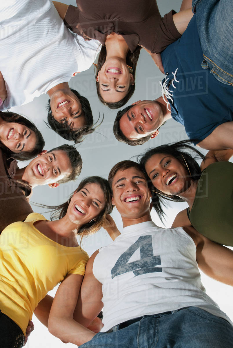 Smiling friends in huddle together - Royalty-free Stock Photo | Dissolve
