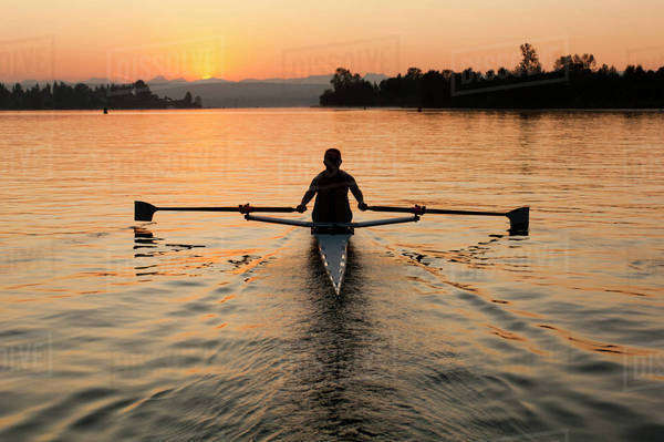 Person rowing sculling boat on river - Royalty-free Stock Photo | Dissolve