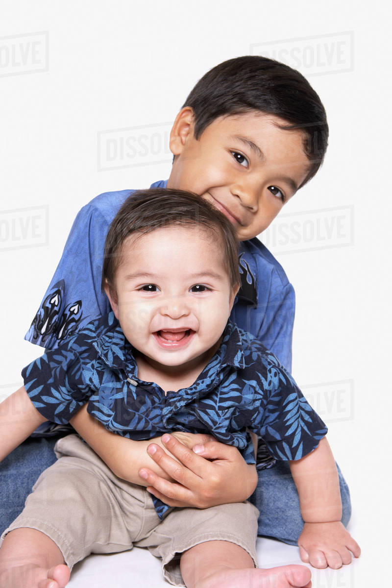 Studio shot of young boy with baby brother - Royalty-free Stock Photo ...