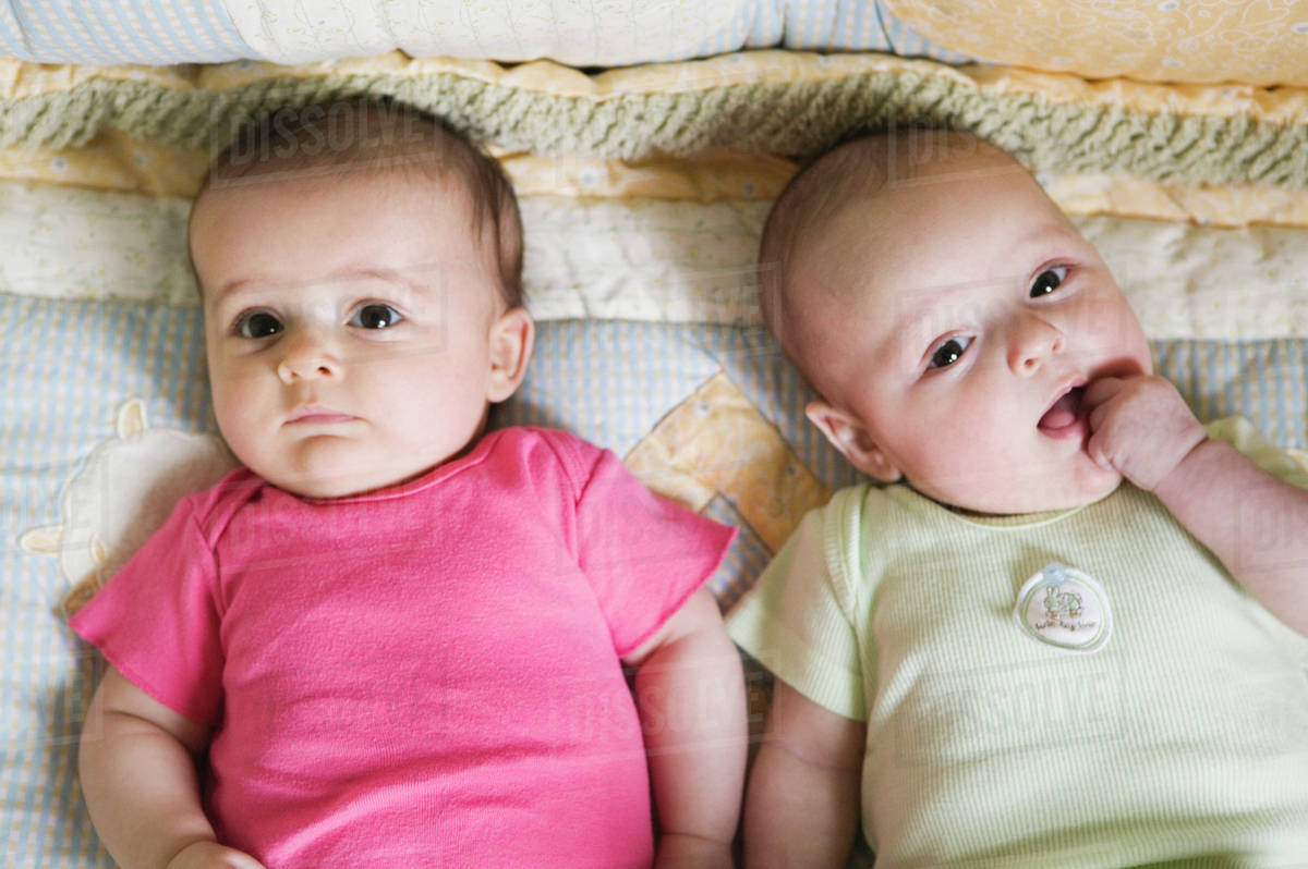 Portrait of two babies on blanket - Royalty-free Stock Photo | Dissolve