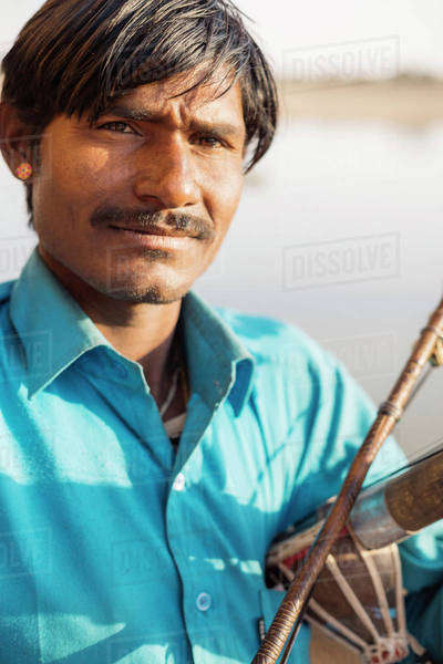 Close up of Indian man holding traditional instrument - Royalty-free ...