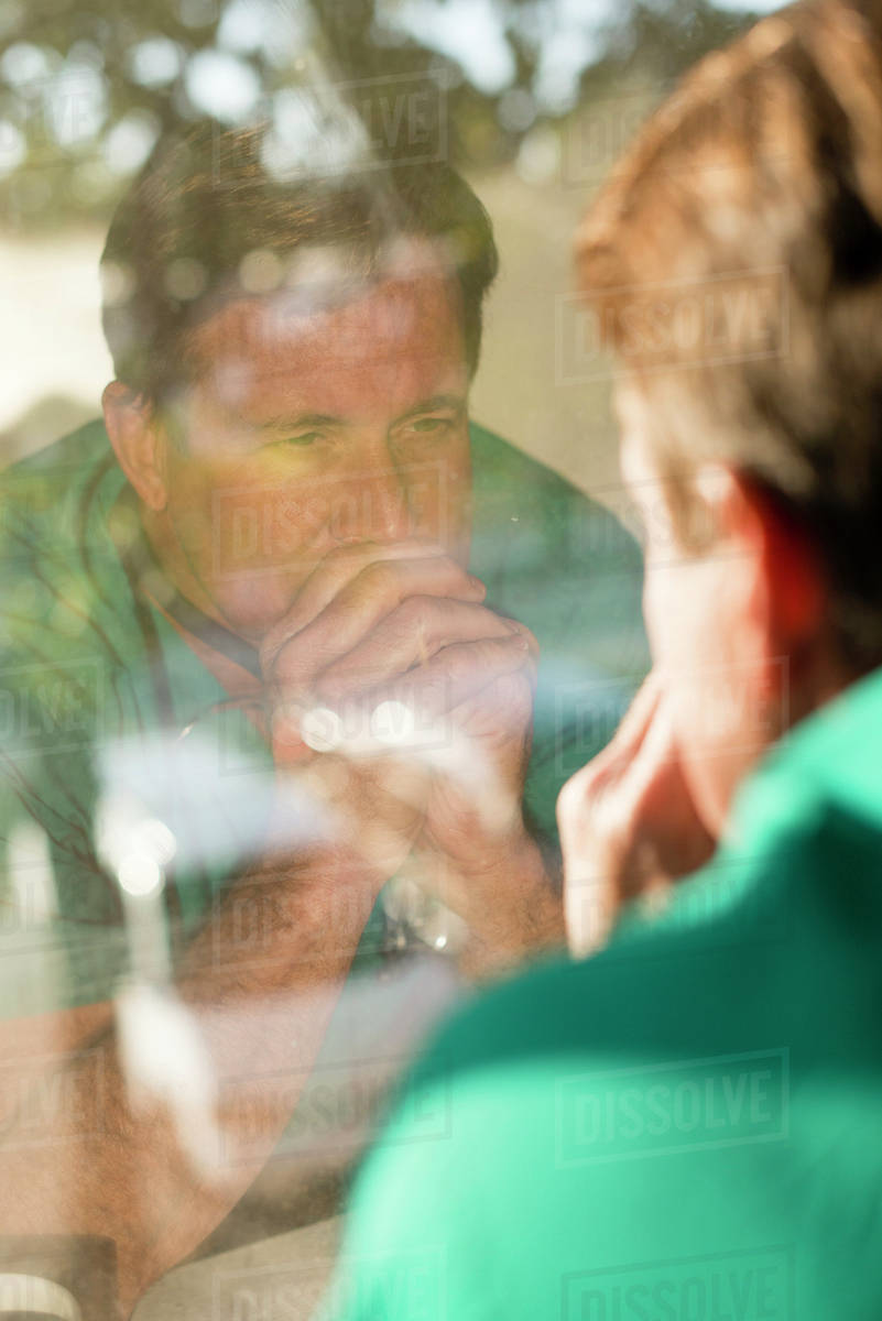 Reflection of Caucasian nurse in window - Stock Photo - Dissolve