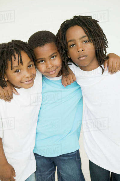 Three African brothers hugging - Stock Photo - Dissolve