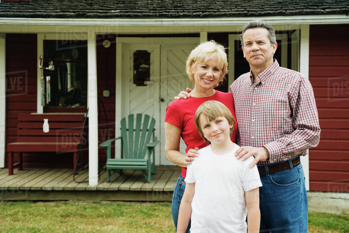 Portrait of family in front of house - Royalty-free Stock Photo | Dissolve