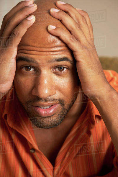 Mixed Race man with hands on head - Royalty-free Stock Photo | Dissolve