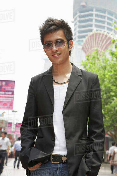 Smiling Chinese man standing outdoors - Royalty-free Stock Photo | Dissolve