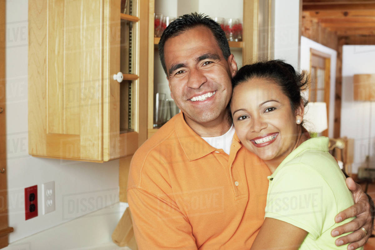 Couple hugging for the camera - Royalty-free Stock Photo | Dissolve