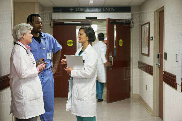 Hospital staff talking in the hallway - Royalty-free Stock Photo | Dissolve