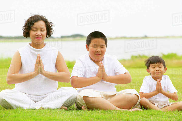Family meditating - Royalty-free Stock Photo | Dissolve
