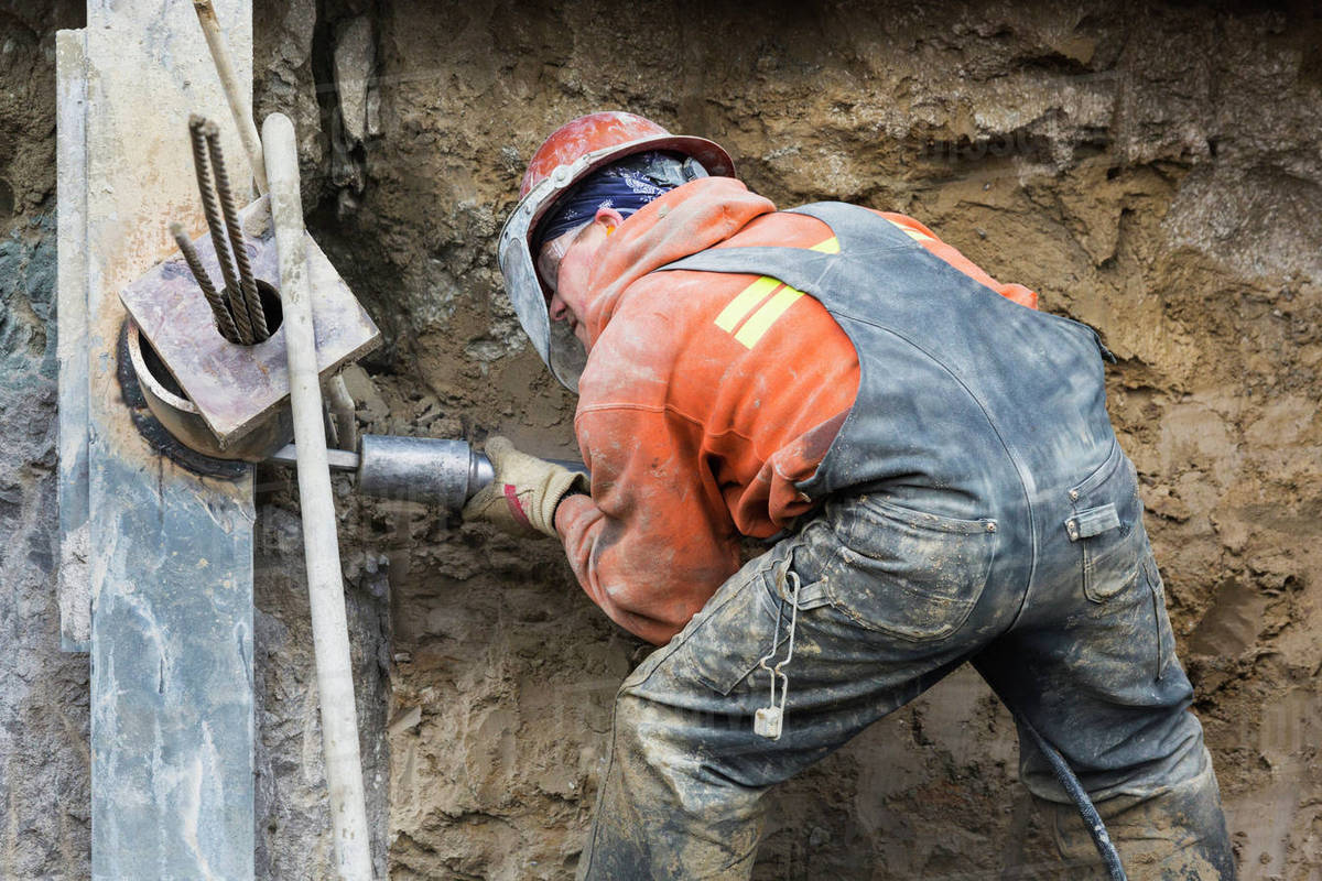 Caucasian worker drilling at construction site - Royalty-free Stock ...