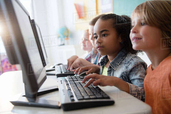 Students using computers in classroom - Stock Photo - Dissolve