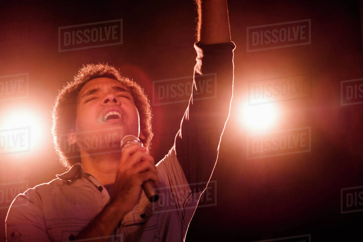 Mixed race singer performing on stage - Royalty-free Stock Photo | Dissolve