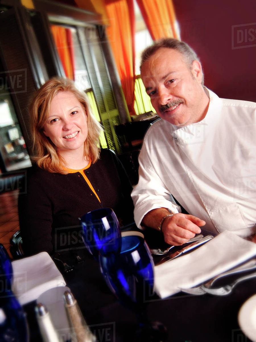 Chef and restaurant owner smiling - Stock Photo - Dissolve