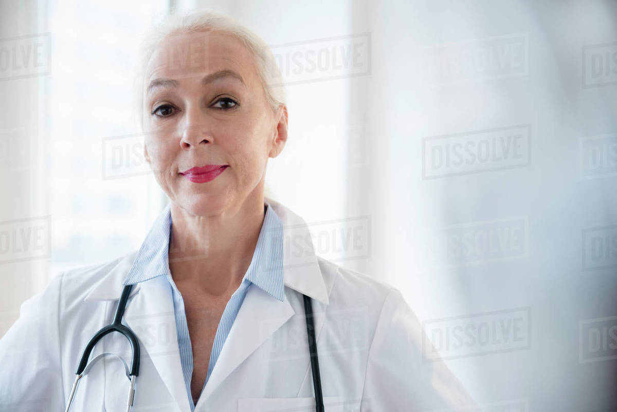 Caucasian doctor wearing stethoscope - Royalty-free Stock Photo | Dissolve