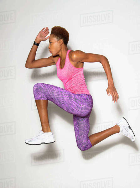 Mixed race athlete sprinting - Royalty-free Stock Photo | Dissolve