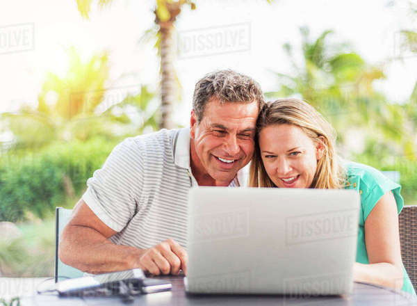 Caucasian couple using laptop outdoors - Royalty-free Stock Photo ...