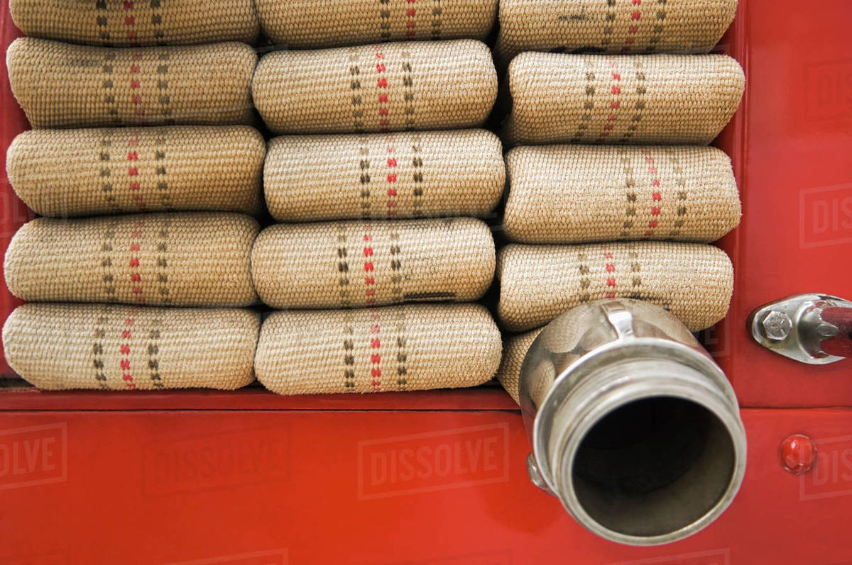 Close up of folded fire hose - Stock Photo - Dissolve