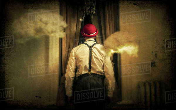 Caucasian man peering through window - Stock Photo - Dissolve