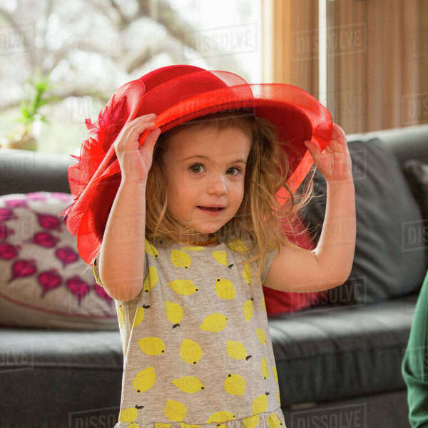 Caucasian preschooler girl playing dress-up with hat - Royalty-free ...