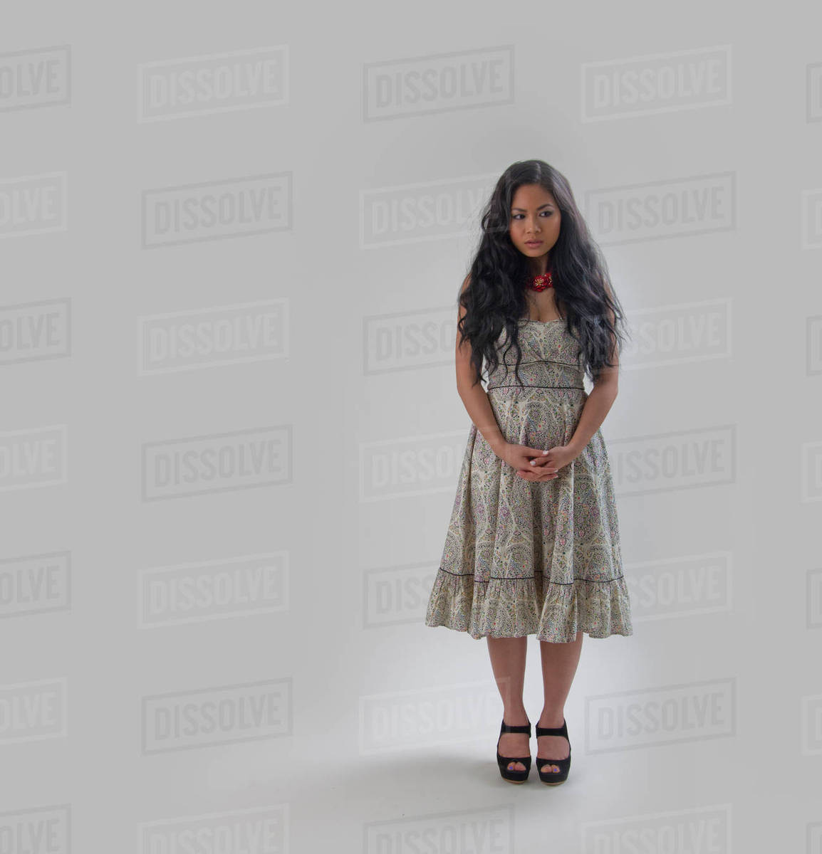 Asian woman standing with hands clasped - Royalty-free Stock Photo ...